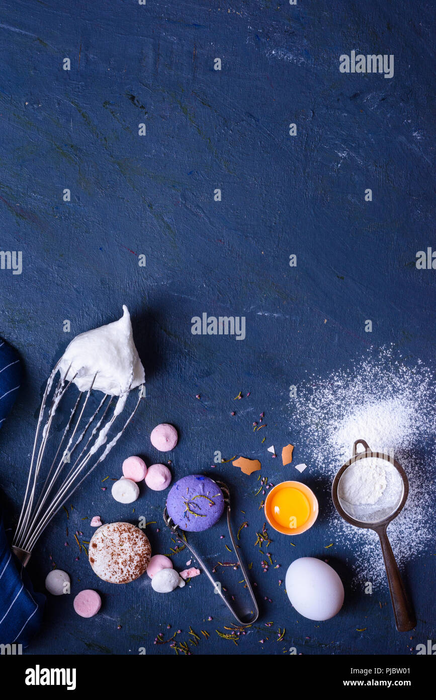 Bakery ingredients - flour, eggs, sugar, yolk, macaroni dessert on blue ...