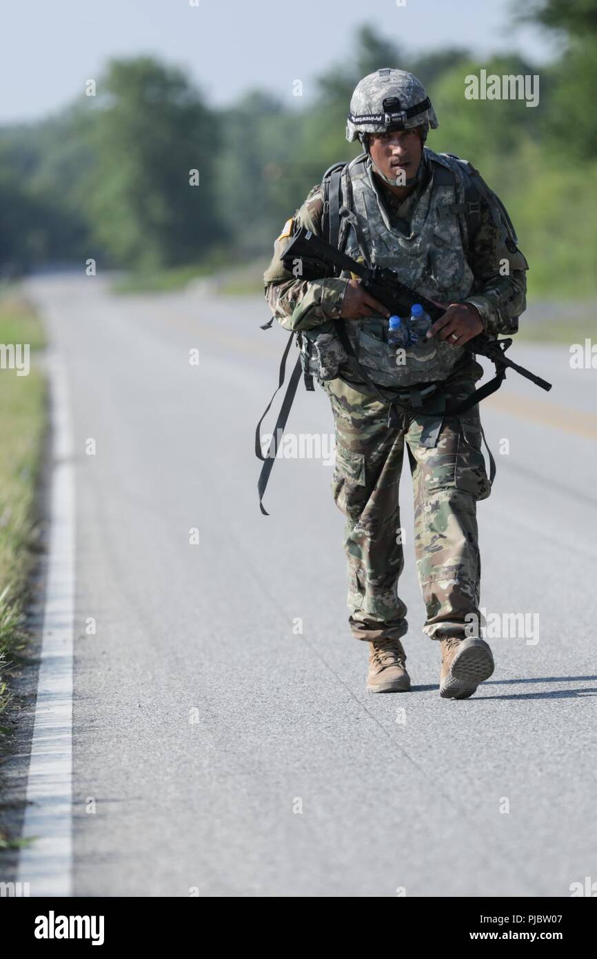 U.S. Army Spc. Jonathan Vasquez marches the final stretch of the ruck ...