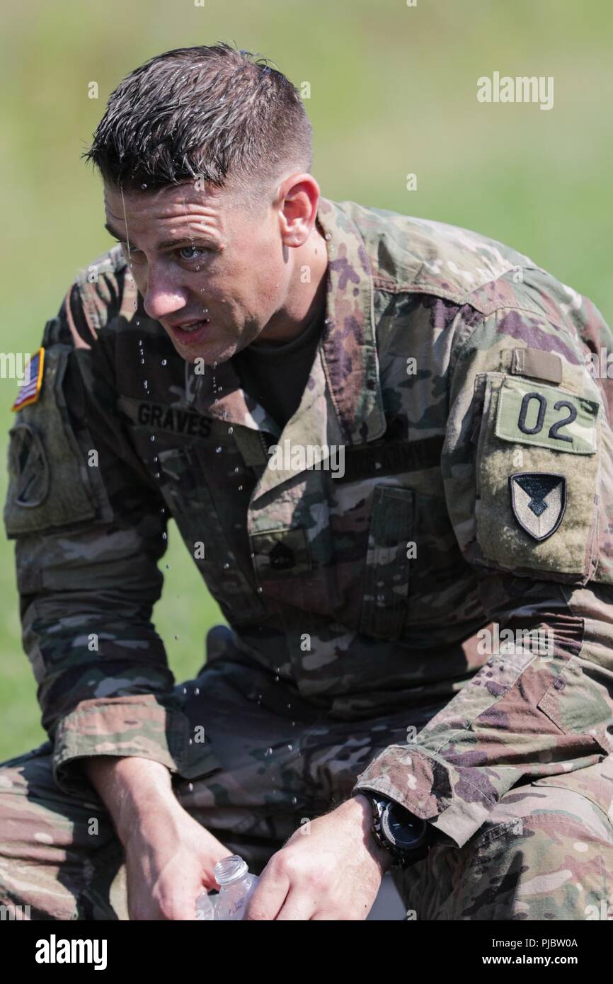 U.S. Army Sgt. 1st Class Joseph Graves takes a break after a 12K ruck ...