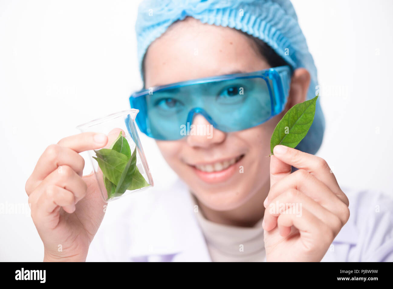 Scientist hand holding green leaf in glass cuvette on laboratory ...