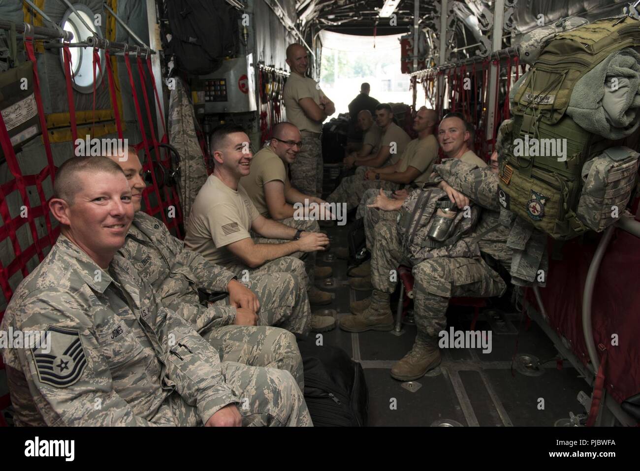 Members of the 103rd Civil Engineer Squadron prepare to fly aboard a C ...