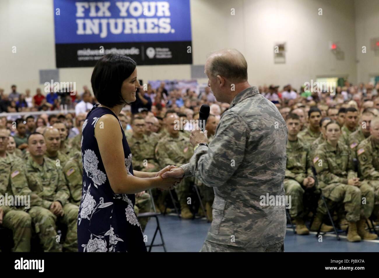 Maj. Gen Don Dunbar, Wisconsin's adjutant general, presents a coin to ...