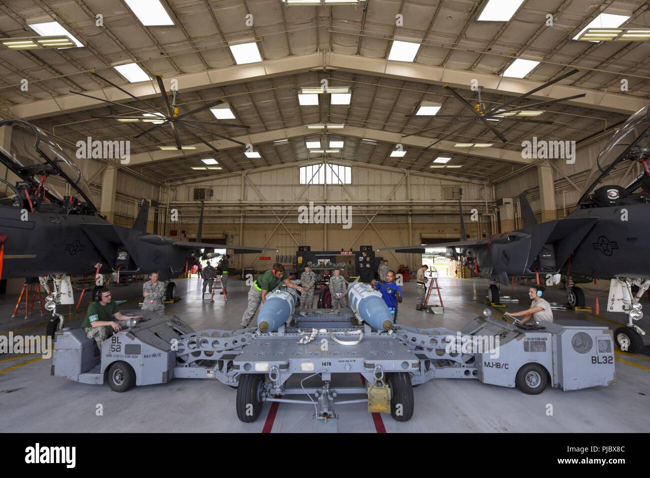 Load crew members of the 335th Aircraft Maintenance Unit (left) and ...