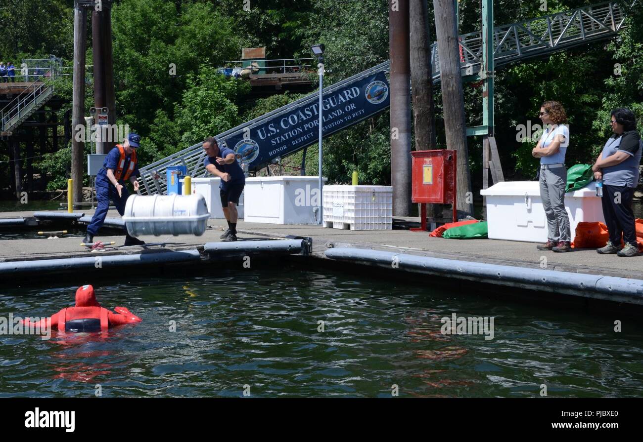 Ron Hilburger, Coast Guard Auxiliary, and Lt. j. g. Adam Birch, U.S ...