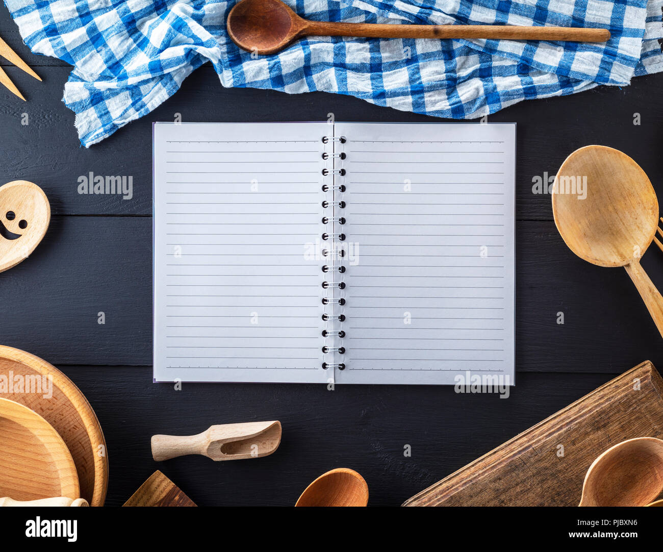 blank open notebook in line and wooden kitchen accessories, recipe ...