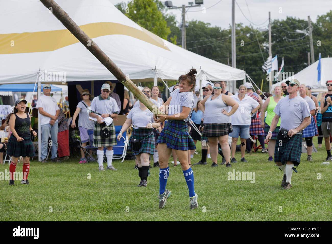 Woman competes in the caber toss at the annual Capital District ...