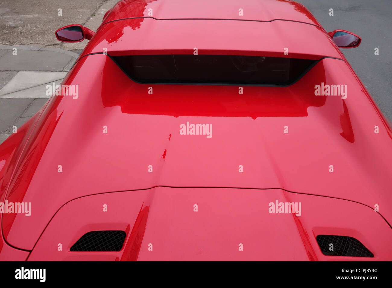 Rear view rear window and a retractable hard-top space on a Red Ferrari ...