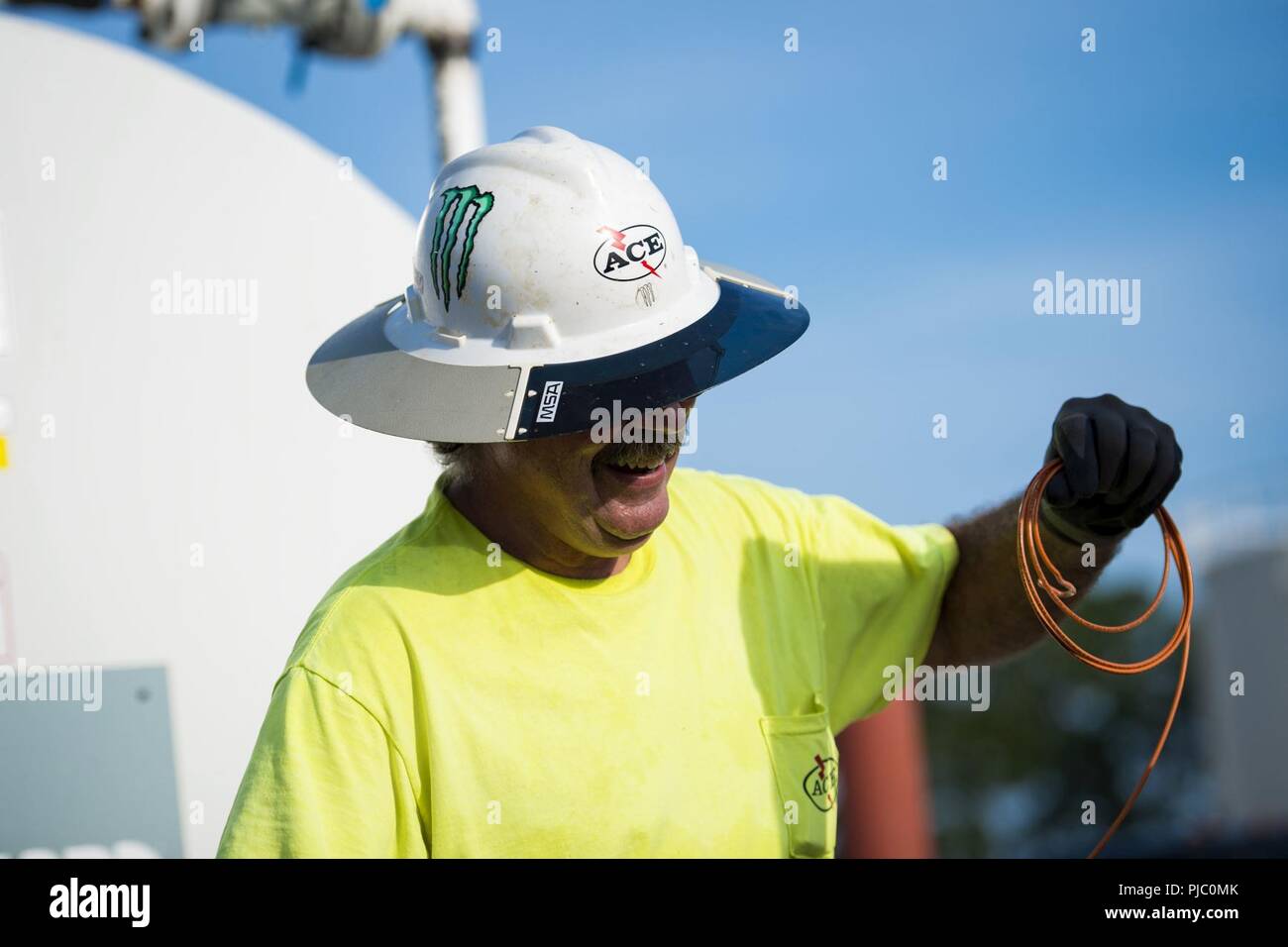 Kevin Yohe, construction superintendent, pulls wire to feed to the fuel ...