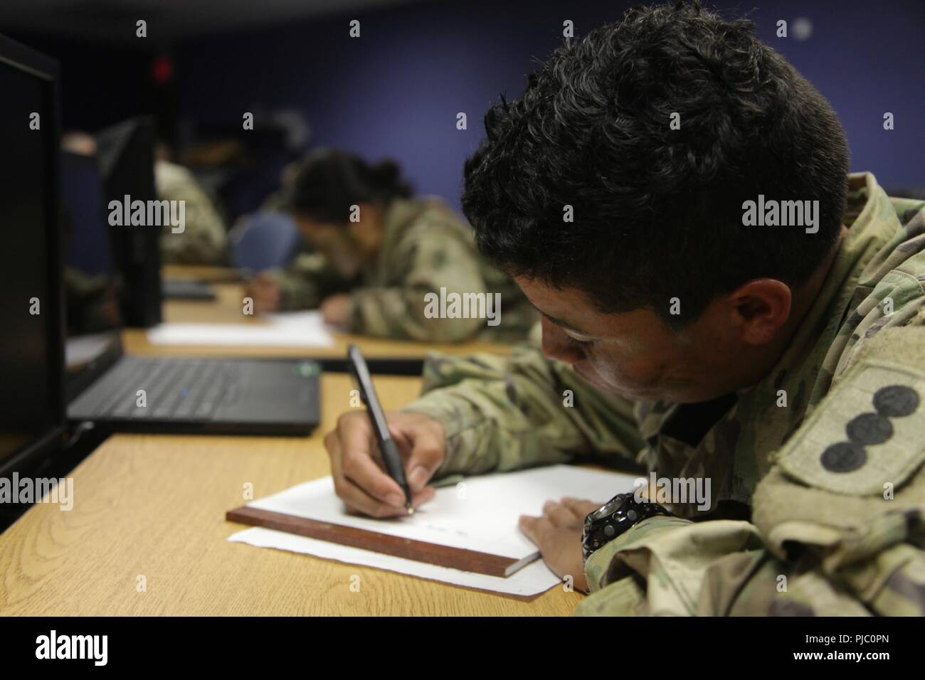U.S. Army Soldiers from various units take the written exam portion of ...