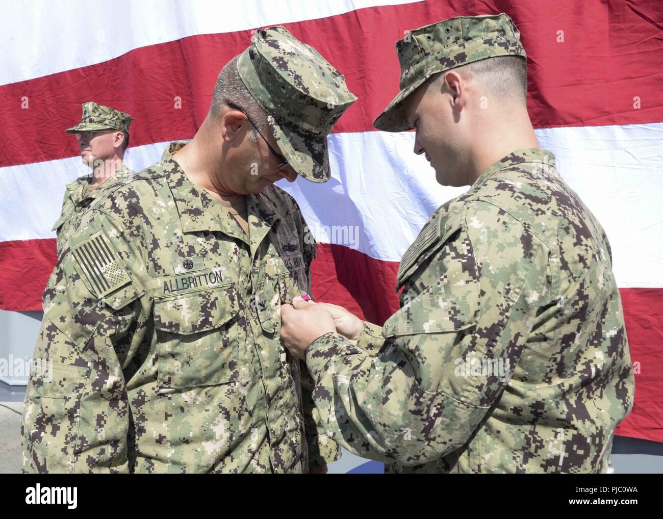 DIEGO (July 19, 2018) Machinist’s Mate 2nd Class Miles Smith pins the ...