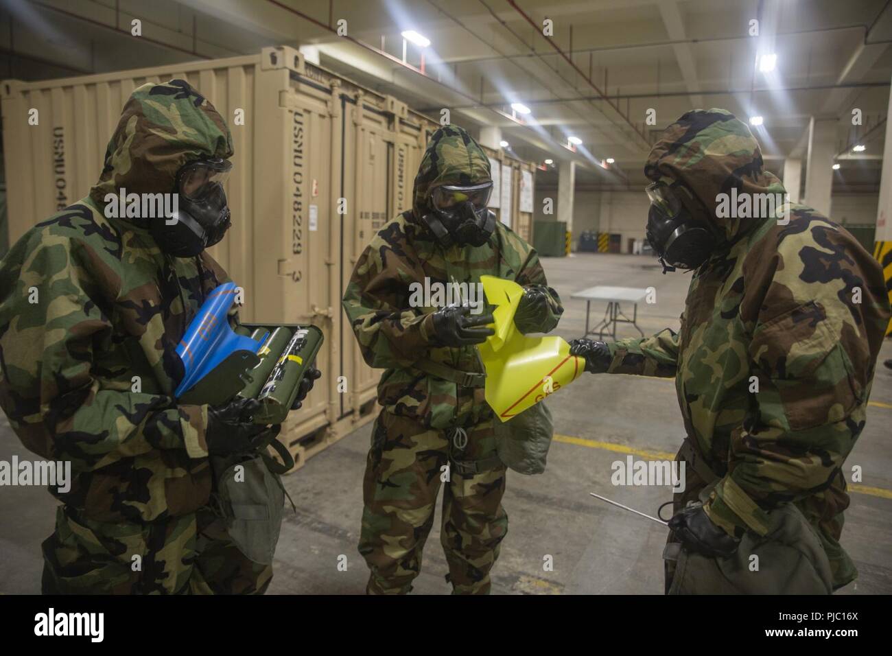Marines place marked flags around a point of contamination during a ...