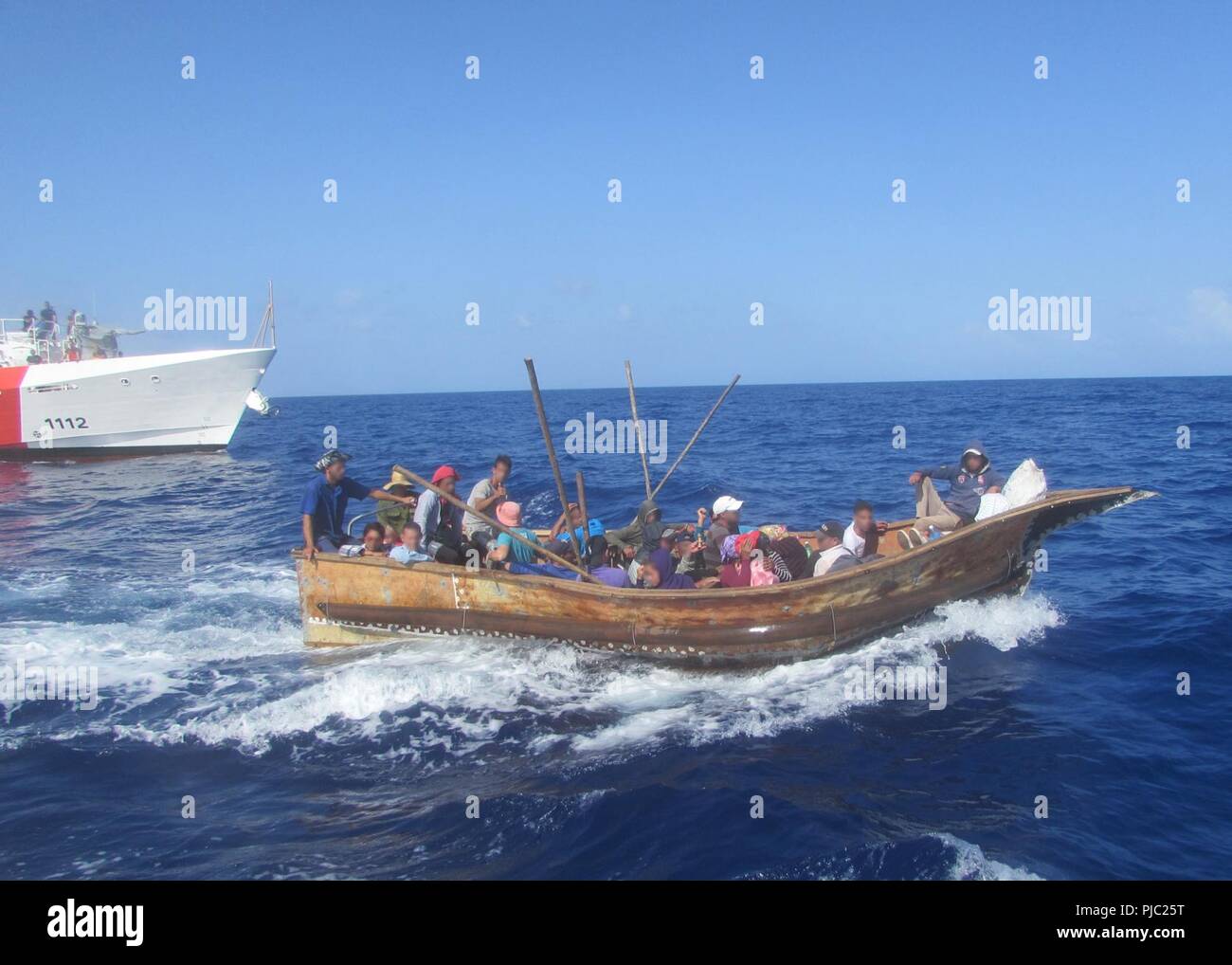 A 26-foot rustic vessel with 28 Cuban migrants makes way through the ...