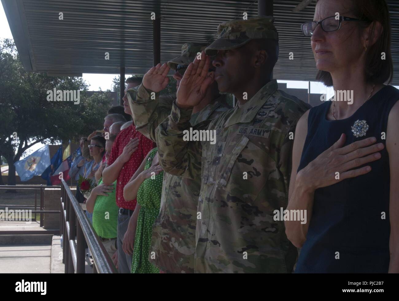 Audience members of the 89th Military Police Brigade Change of Command render appropriate honors ...