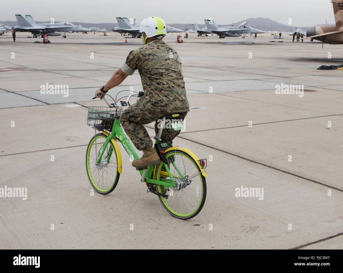 U.S. Marine Corps Maj. Brandon Newell, rides a lime bike on the ...