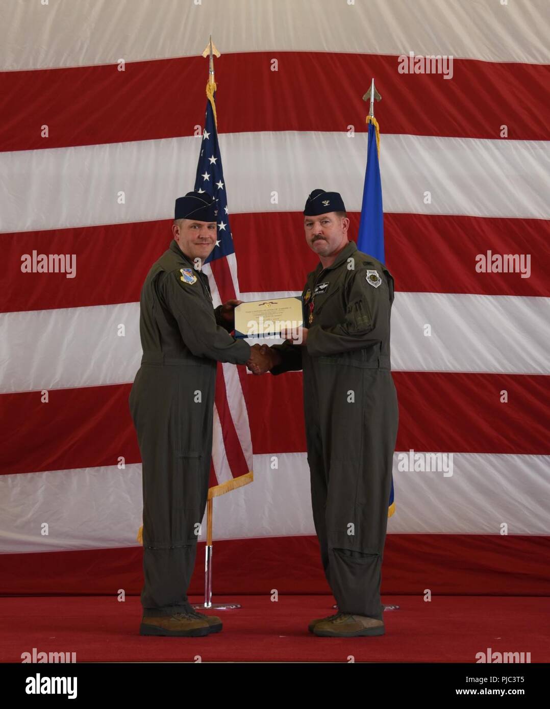 U.S. Air Force Col. David W. Abba, 53rd Wing commander (left), presents ...