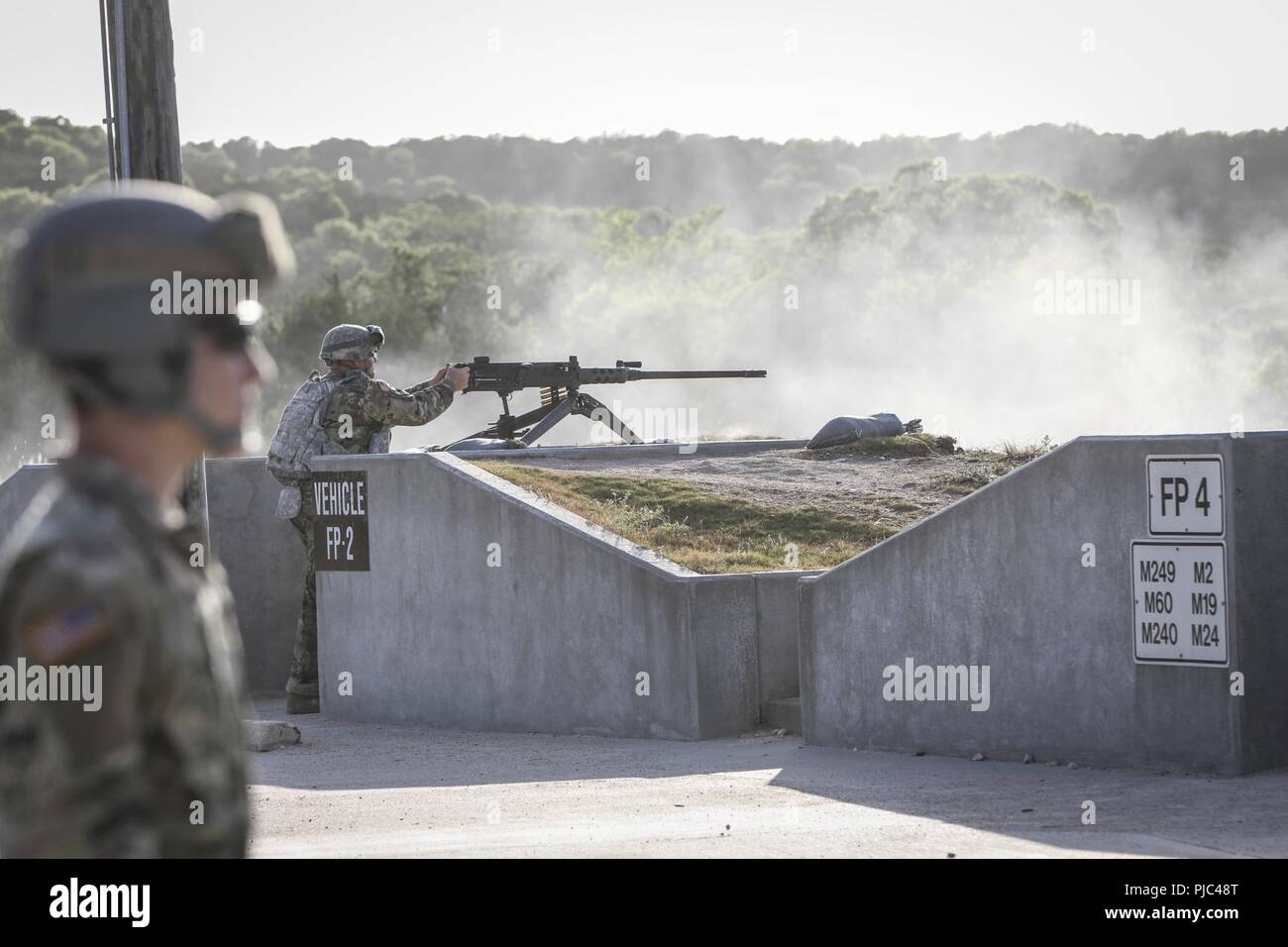 An Army Reserve Soldier keeps an eye on gunnery operations at a M2 .50 ...