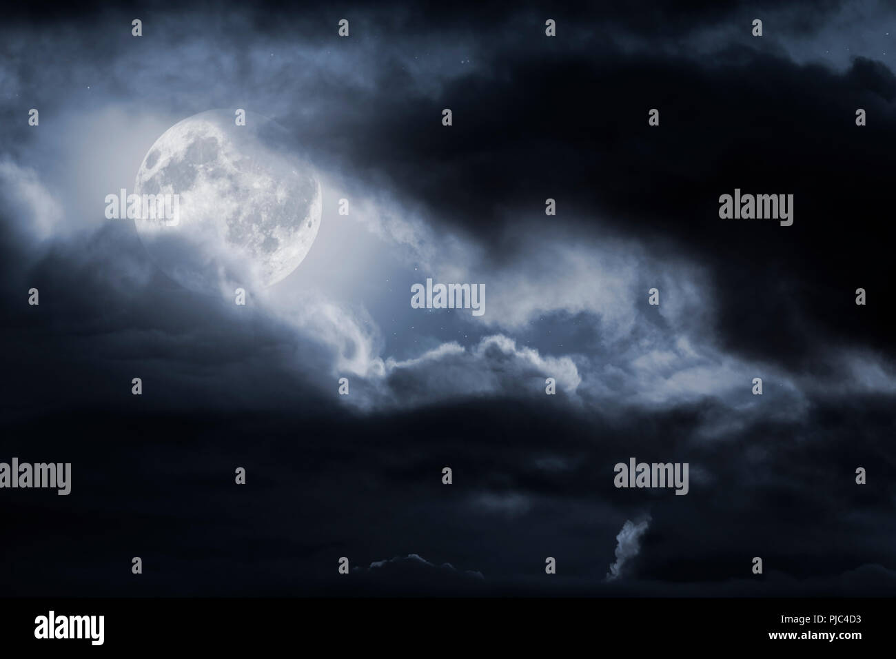 Cloudy full moon night sky. Toned blue Stock Photo - Alamy