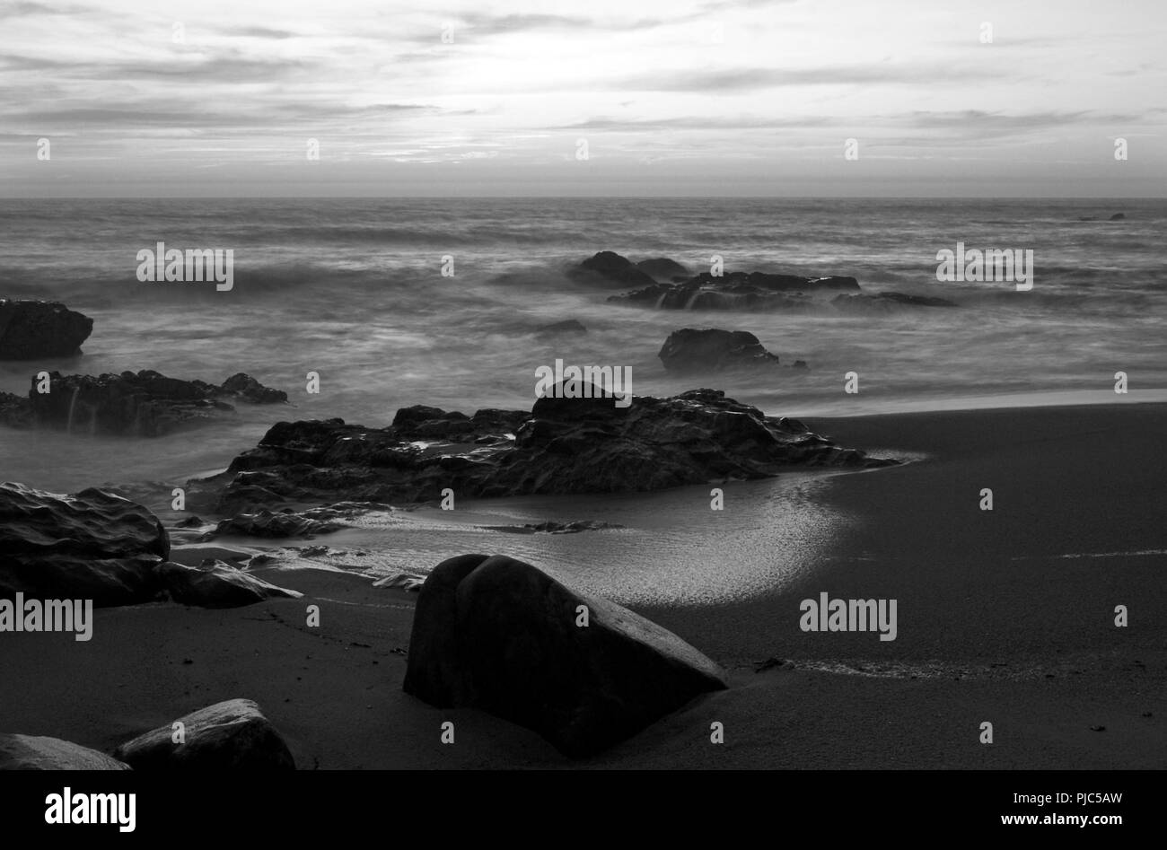 Moody sunset photographed in a rocky seaside in the north of Portugal ...