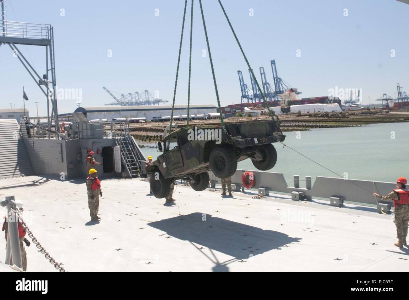 Army Reserve Soldiers load the first of six vehicles onto the U.S. Army ...