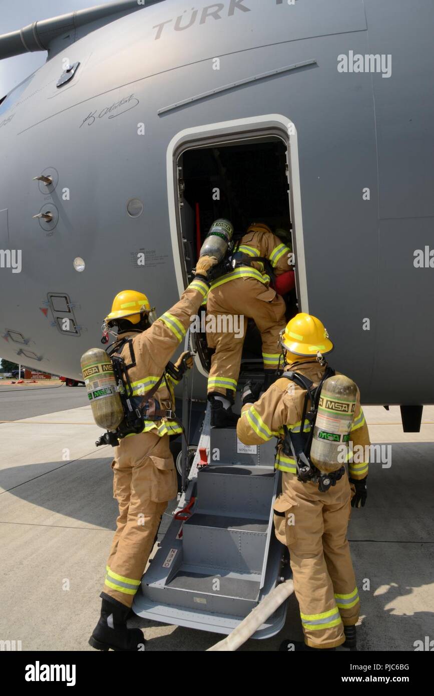 U.S. Airmen assigned to 424th Air Base Squadron, evacuate a victim out ...