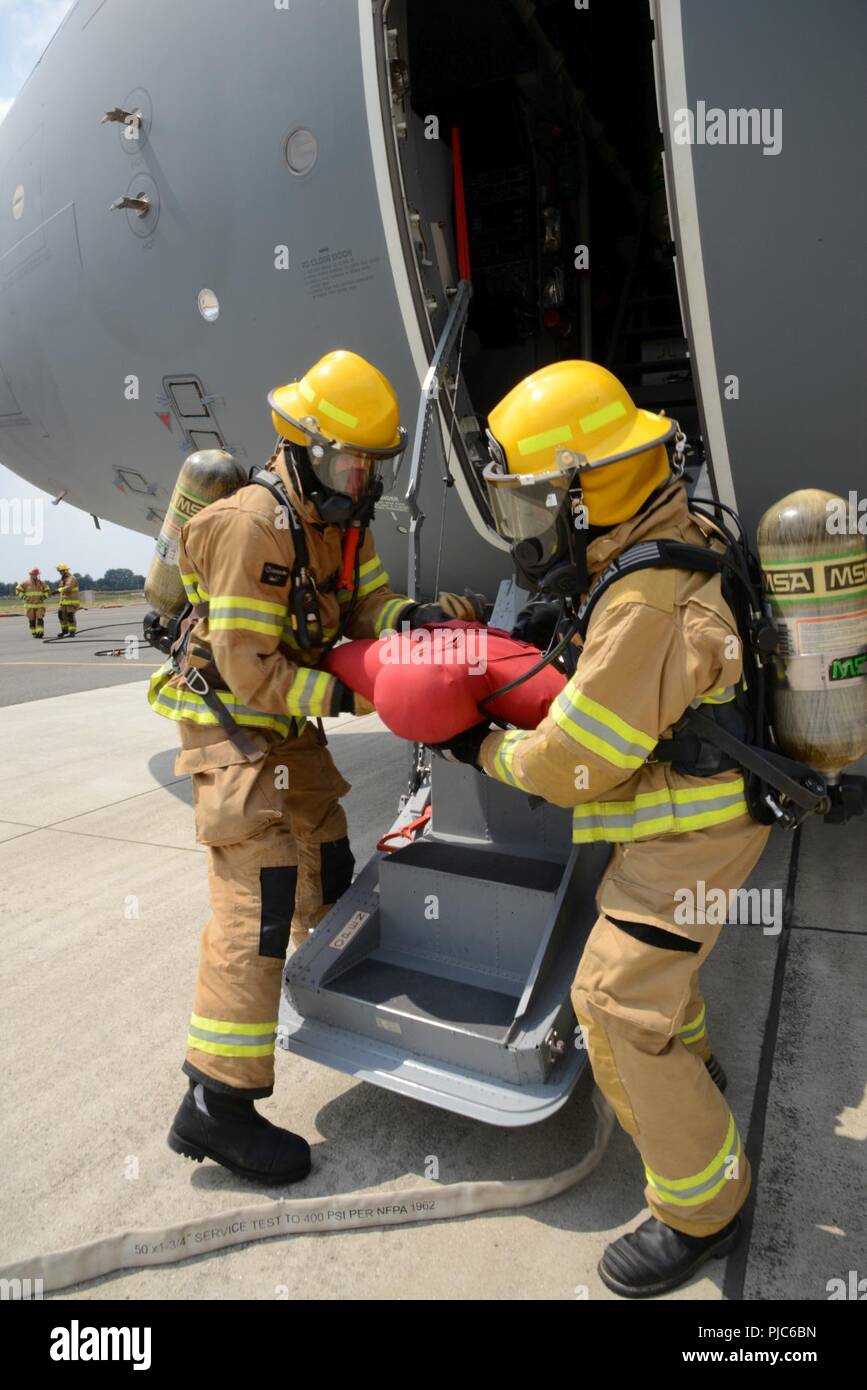 U.S. Airmen assigned to 424th Air Base Squadron, evacuate a victim out ...