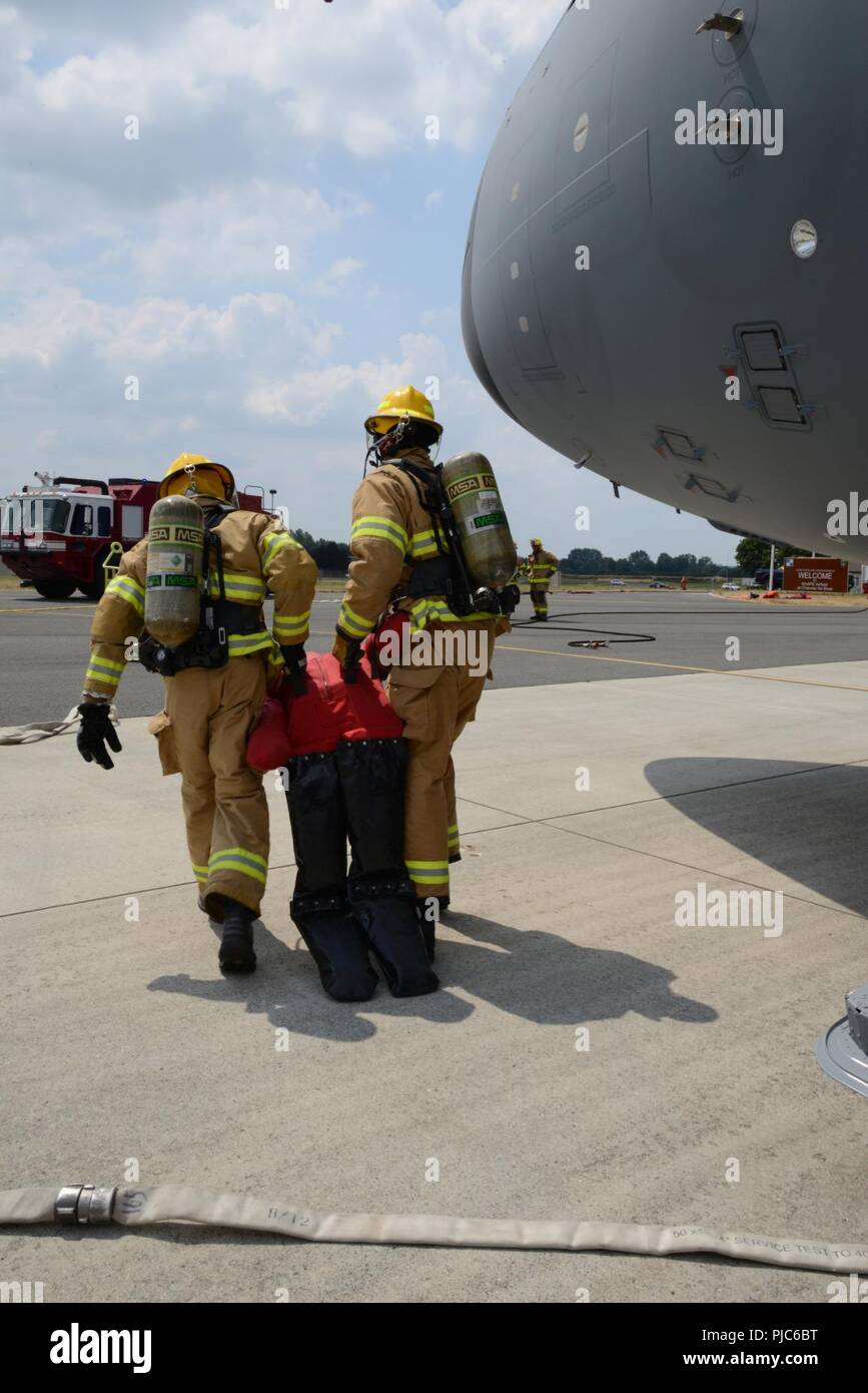 U.S. Airmen assigned to 424th Air Base Squadron, evacuate a victim out ...