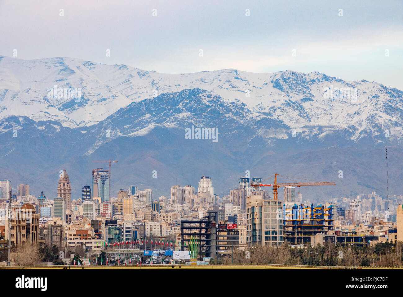 Islamic Republic of Iran. Tehran city center and mountainous background ...