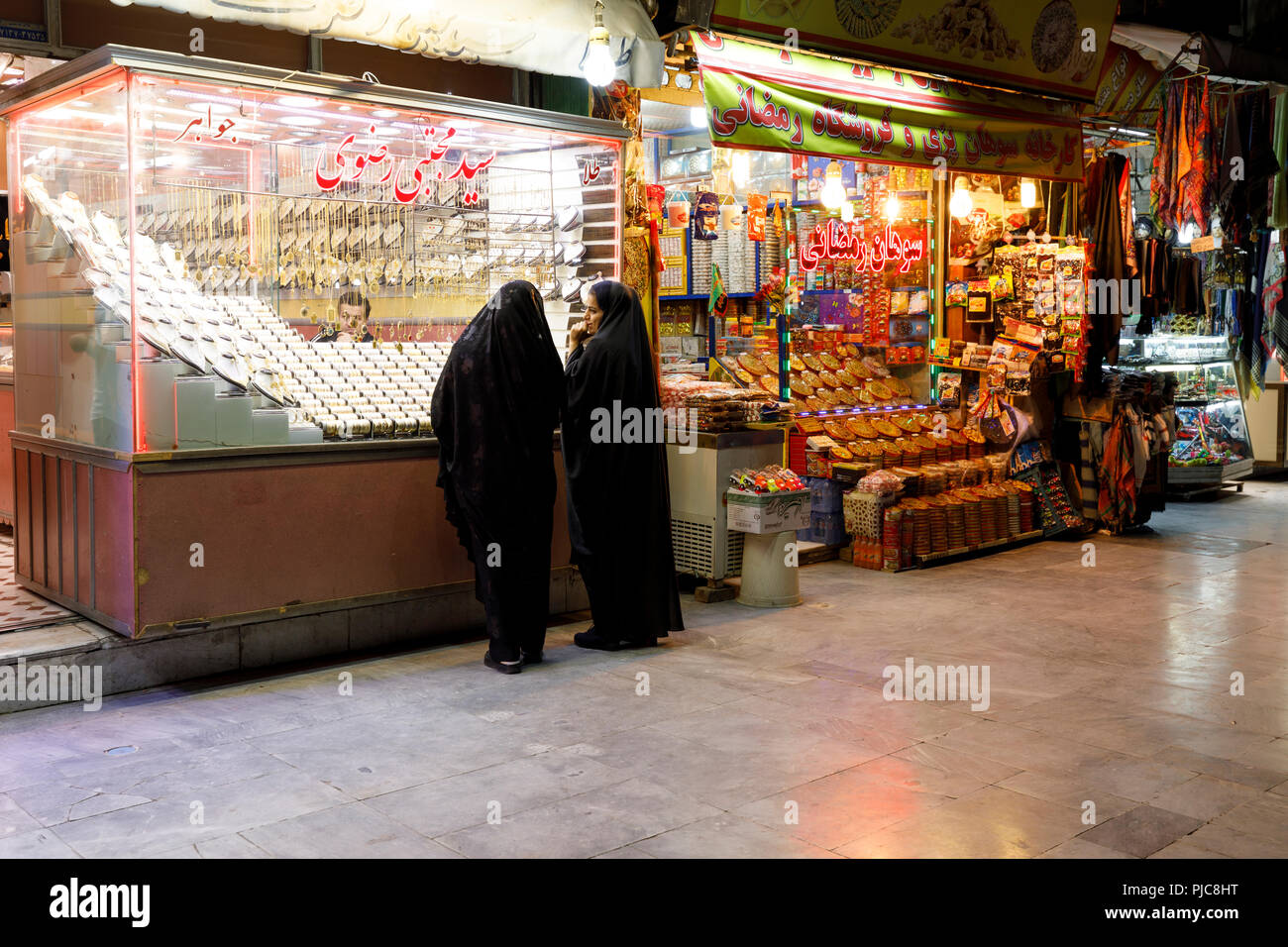 Islamic Republic of Iran. Qom. 2 Women looking at gold store window ...