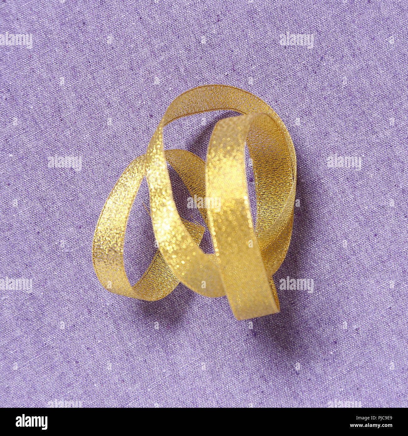 Curly gold ribbon satin hi-res stock photography and images - Alamy