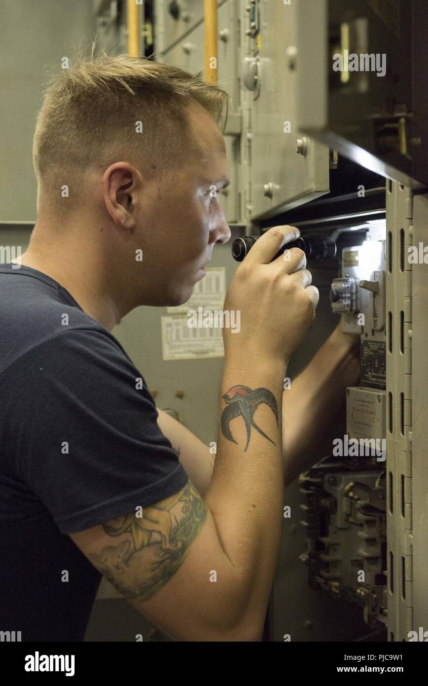 Electrician’s Mate (Nuclear) 2nd Class Casey Hannick inspects fuses in ...