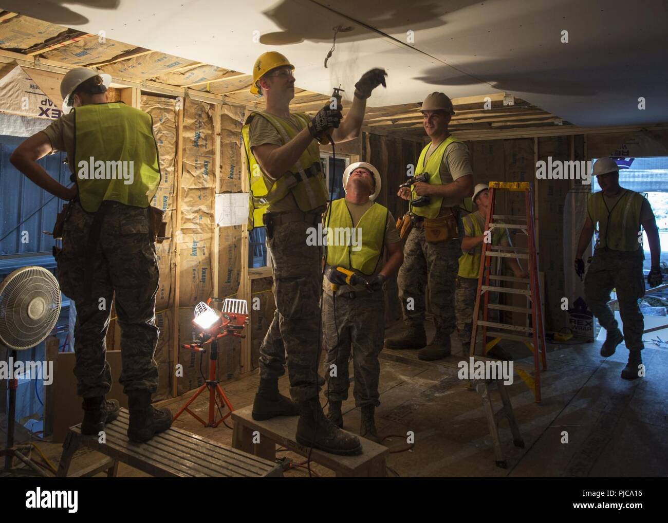 U.S. Air Force Airmen from the 133rd Civil Engineer Squadron hang and ...