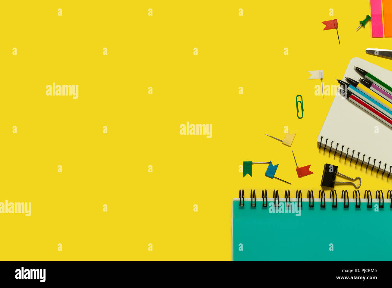 multiple office stationary on a yellow surface Stock Photo - Alamy
