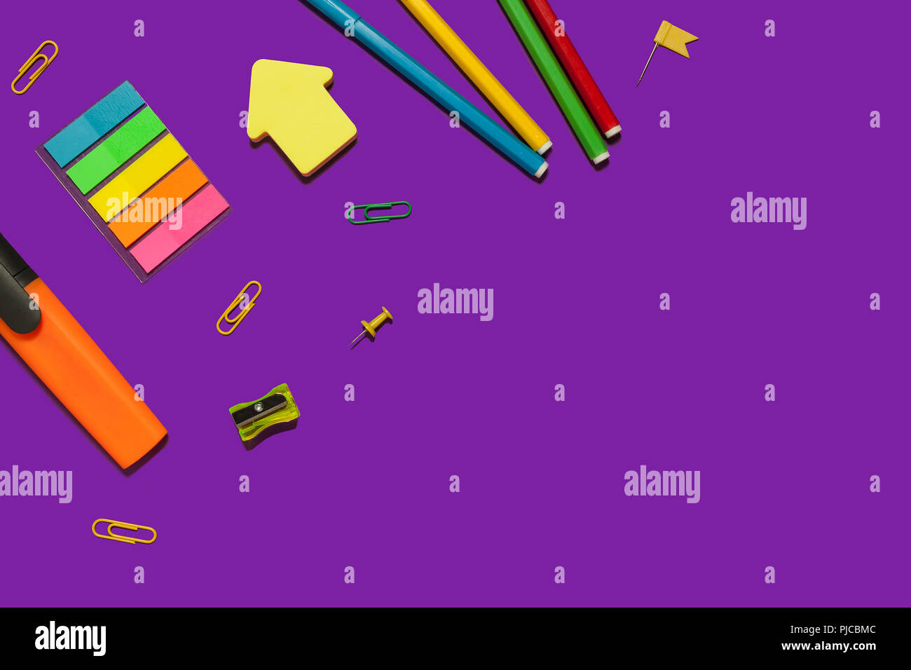 set of various school supplies on a purple surface Stock Photo - Alamy