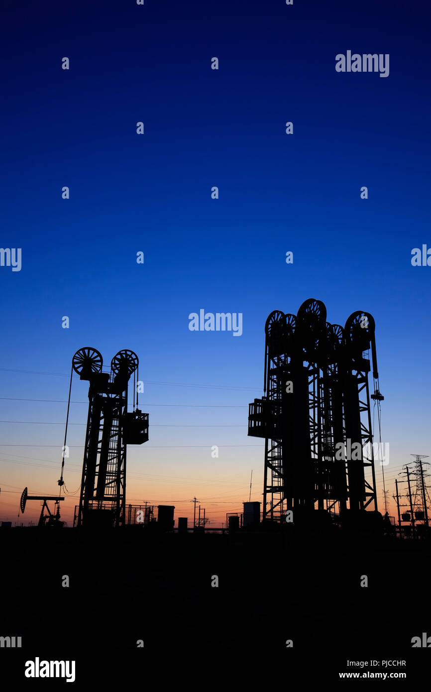 Oil field, the tower type pumping unit in the evening Stock Photo - Alamy