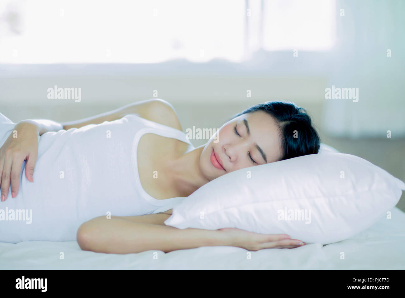 Asian girl sleeping on the white bed Stock Photo - Alamy