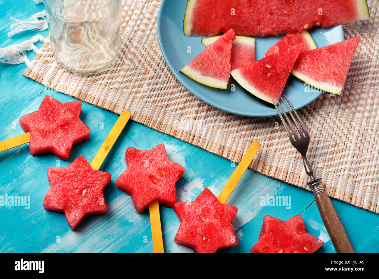 Watermelon slices and stars in wooden background Stock Photo - Alamy