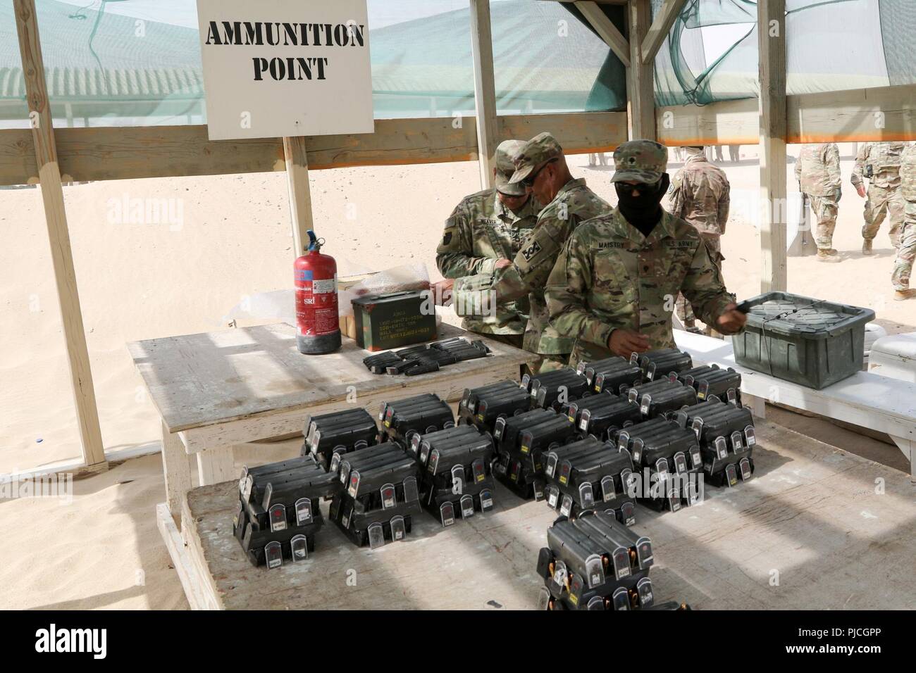 CAMP BUEHRING, Kuwait – Soldiers load M9 magazines at the ammunition ...
