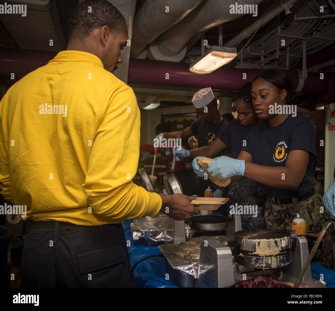 PACIFIC OCEAN (July 22, 2018) Airman Mia Pierce serves waffles to a ...
