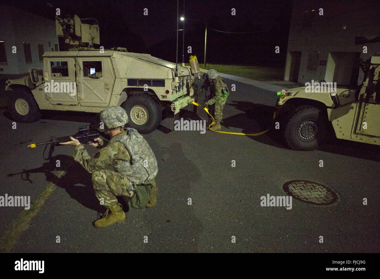 Infantry Soldiers recover a disabled Humvee during a night mission to ...