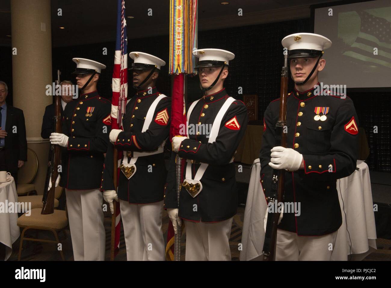 The U.S. Marine Corps Color Guard presents the National Ensign and the ...