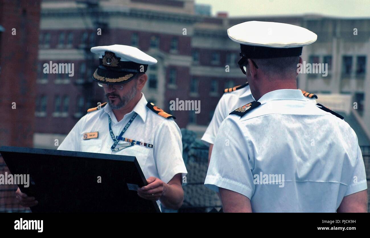 Commodore Tom Guy, UK Royal Navy, reads a commissioning warrant that ...