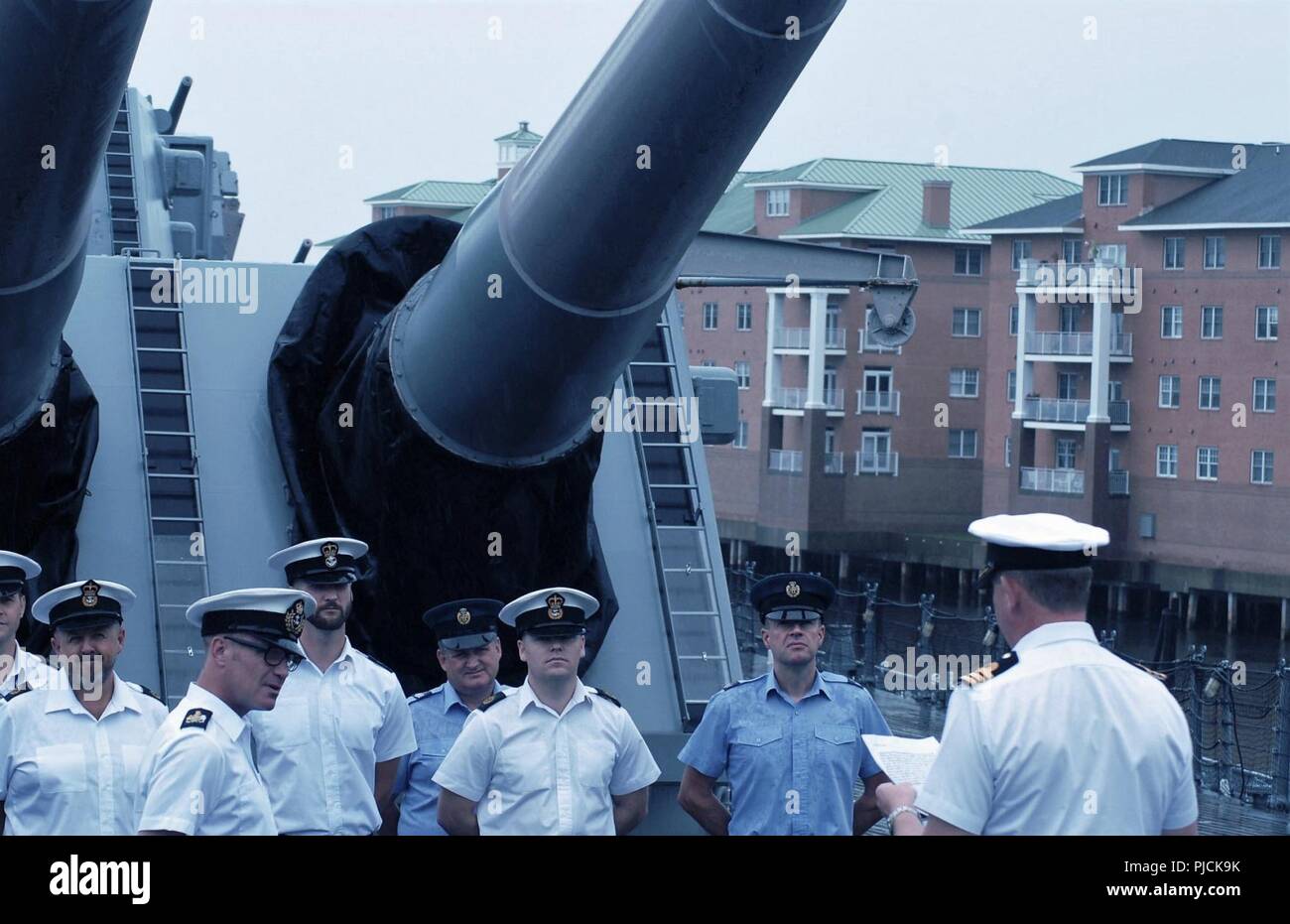 Service members with the UK Royal Navy are pictured in-front of turret ...