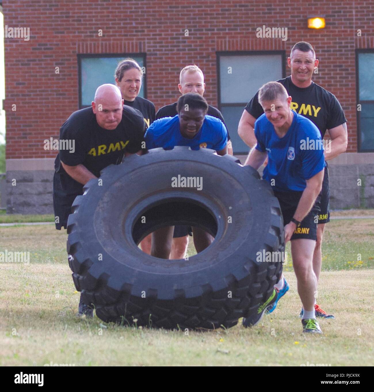 10th Mountain Division's Mountain 7, CSM Jason Roark (right) helps flip ...