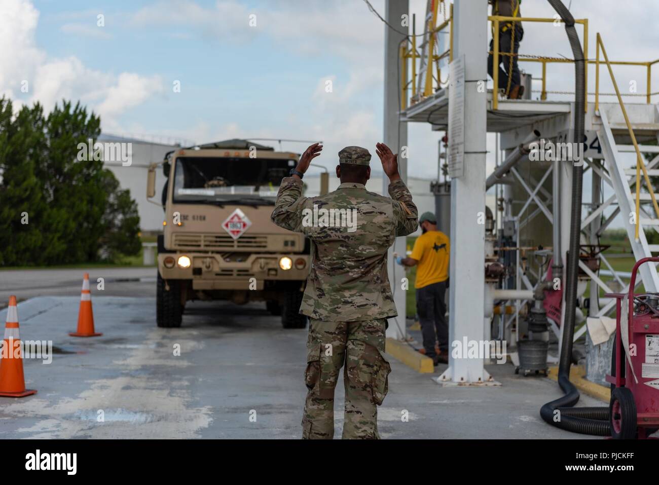 A Soldier from the 61st Quartermaster Battalion guides an M1088 Tractor ...