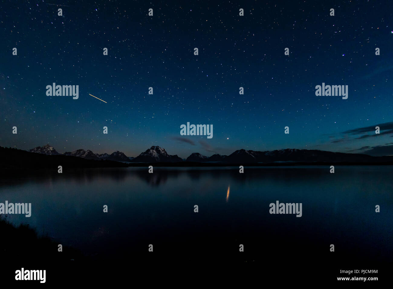 Airplane Light and Stars over Jackson Lake and Grand Teton Range Stock ...