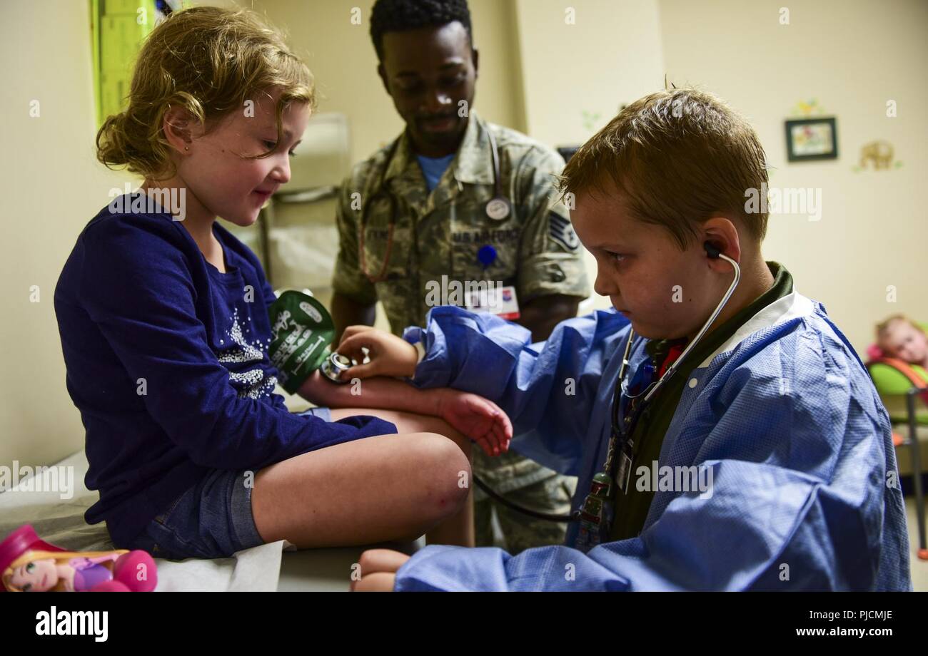 Caleb Pettit, 9, checks a patient’s heartbeat while playing doctor ...