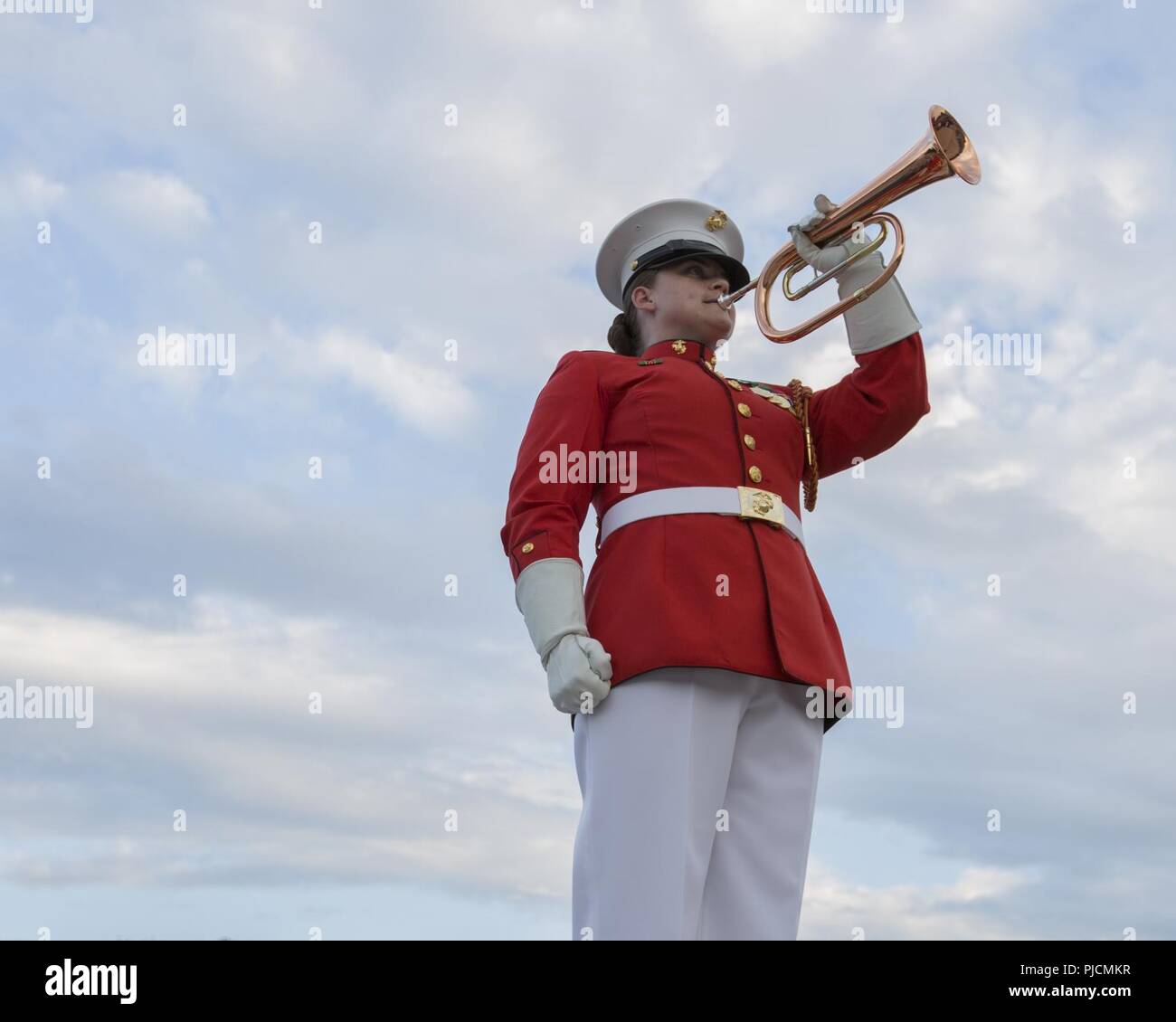 A bugler from the U.S. Marine Corps Drum and Bugle Corps plays taps ...