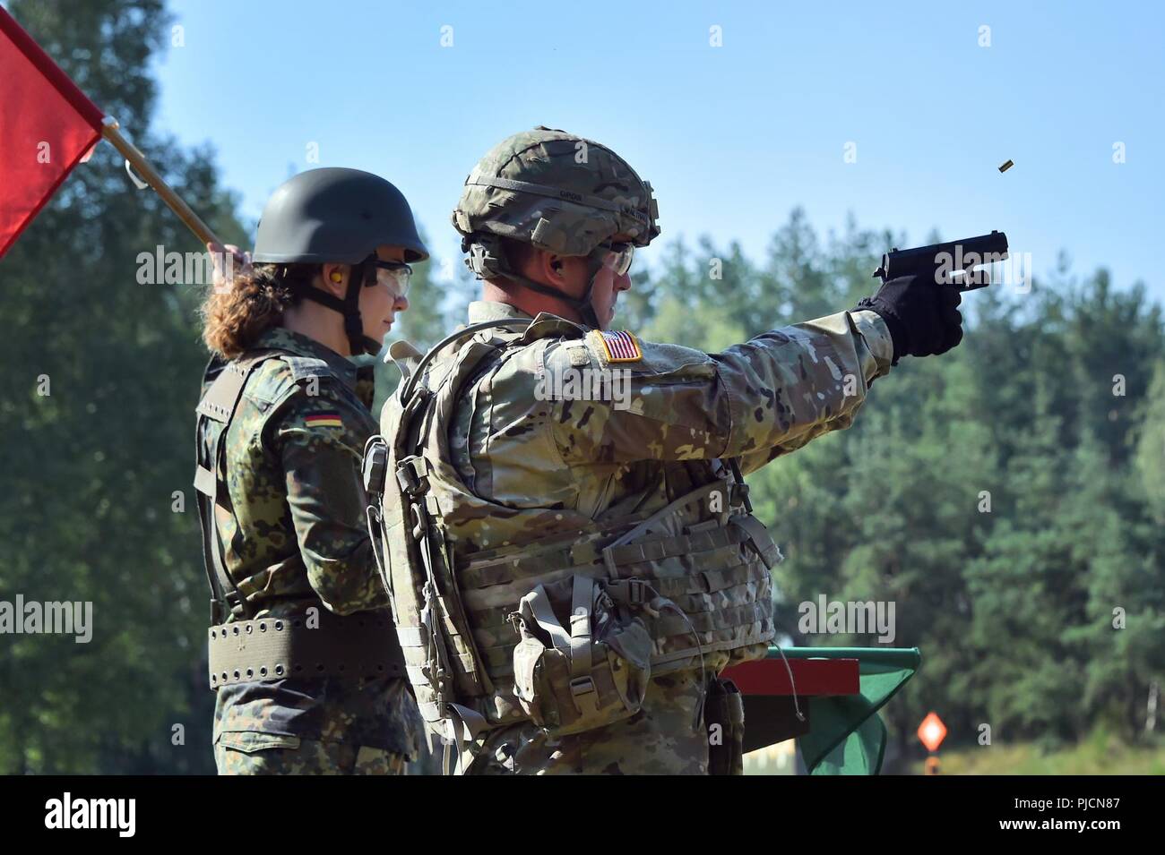 A German reserve soldier, left, conducts range safety for a U.S ...