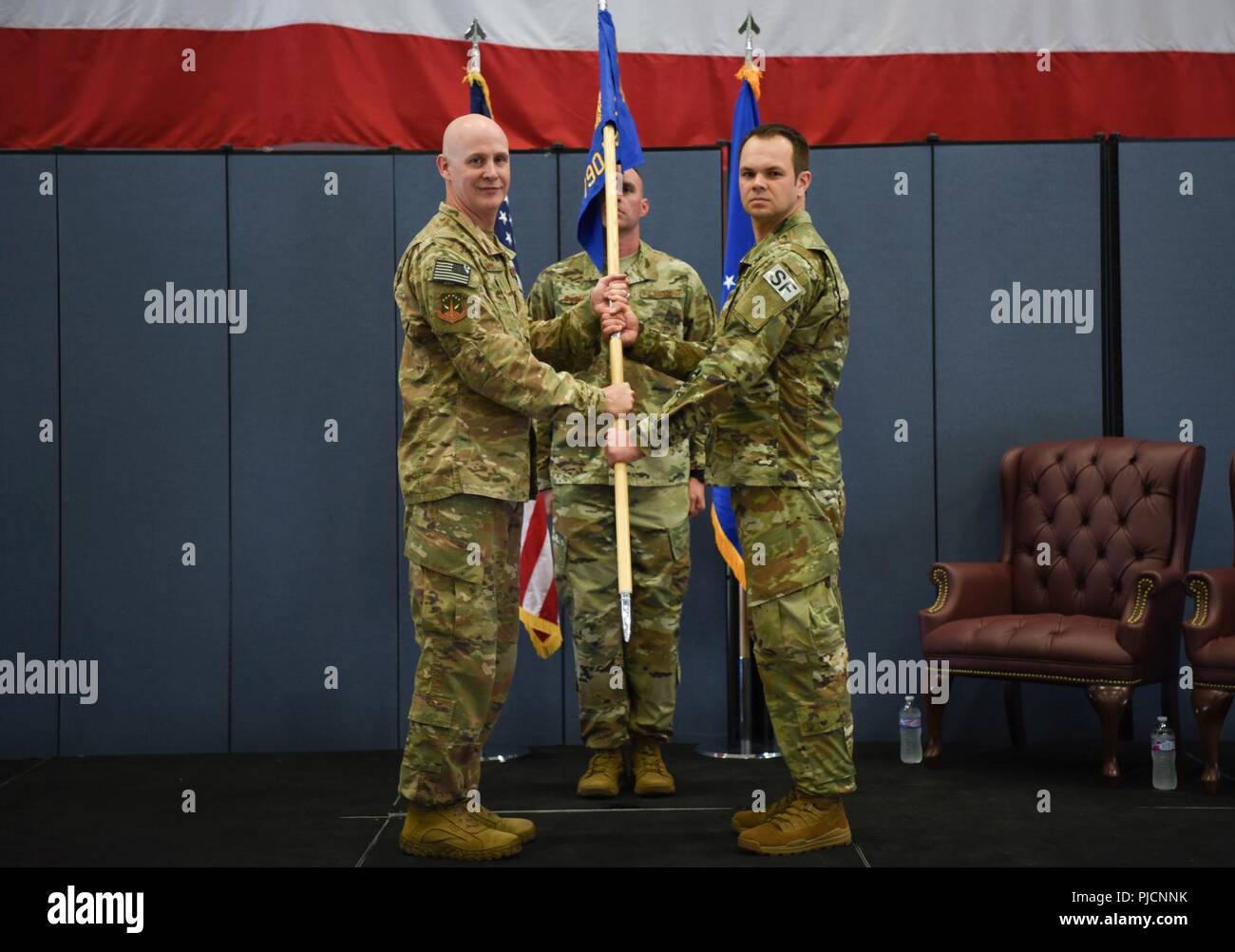 Colonel John Grimm, 90th Security Forces Group commander, passes the guidon to Maj. Jaroslaw ...