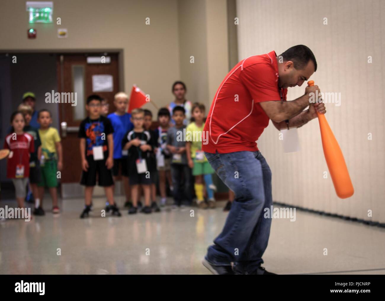 A Soldier-volunteer demonstrates an exercise activity for kids at ...